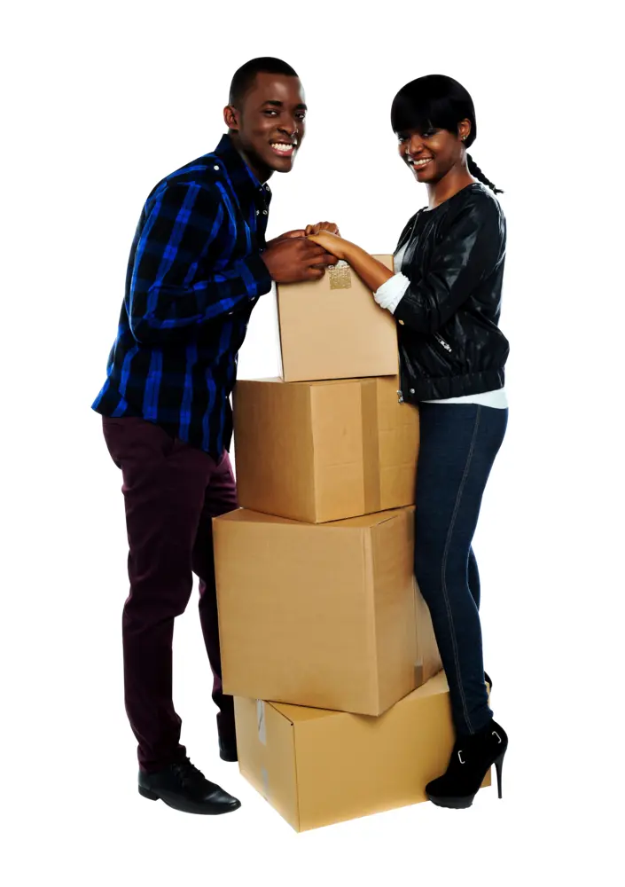 Smiling Couple with Stacked Shipping Boxes